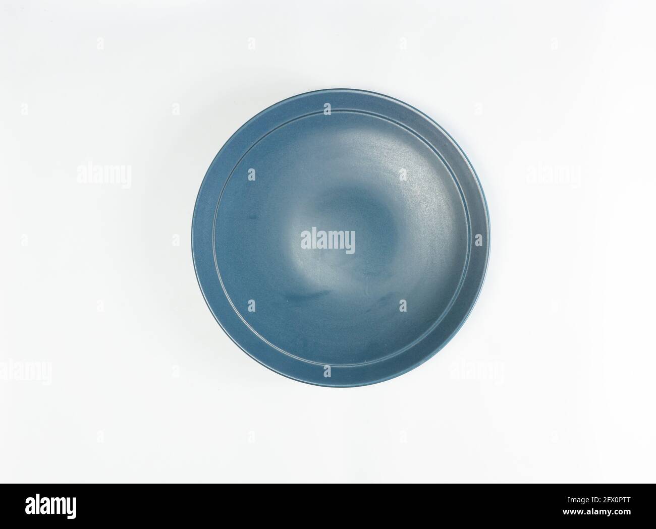 Indonesian-made ceramic plates are Tosca green on a white background ...