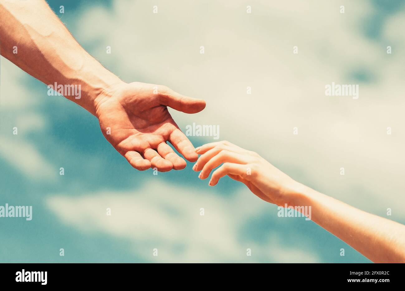 Giving a helping hand. Hands of man and woman reaching to each other ...