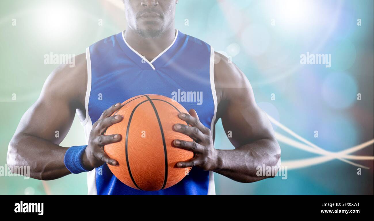 Composition of midsection of basketball player holding ball with copy ...