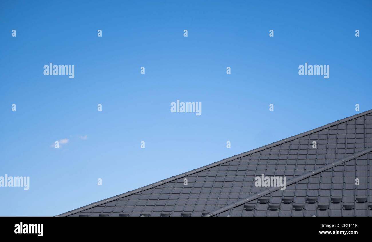 Brown corrugated metal profile roof installed on a modern house. The ...