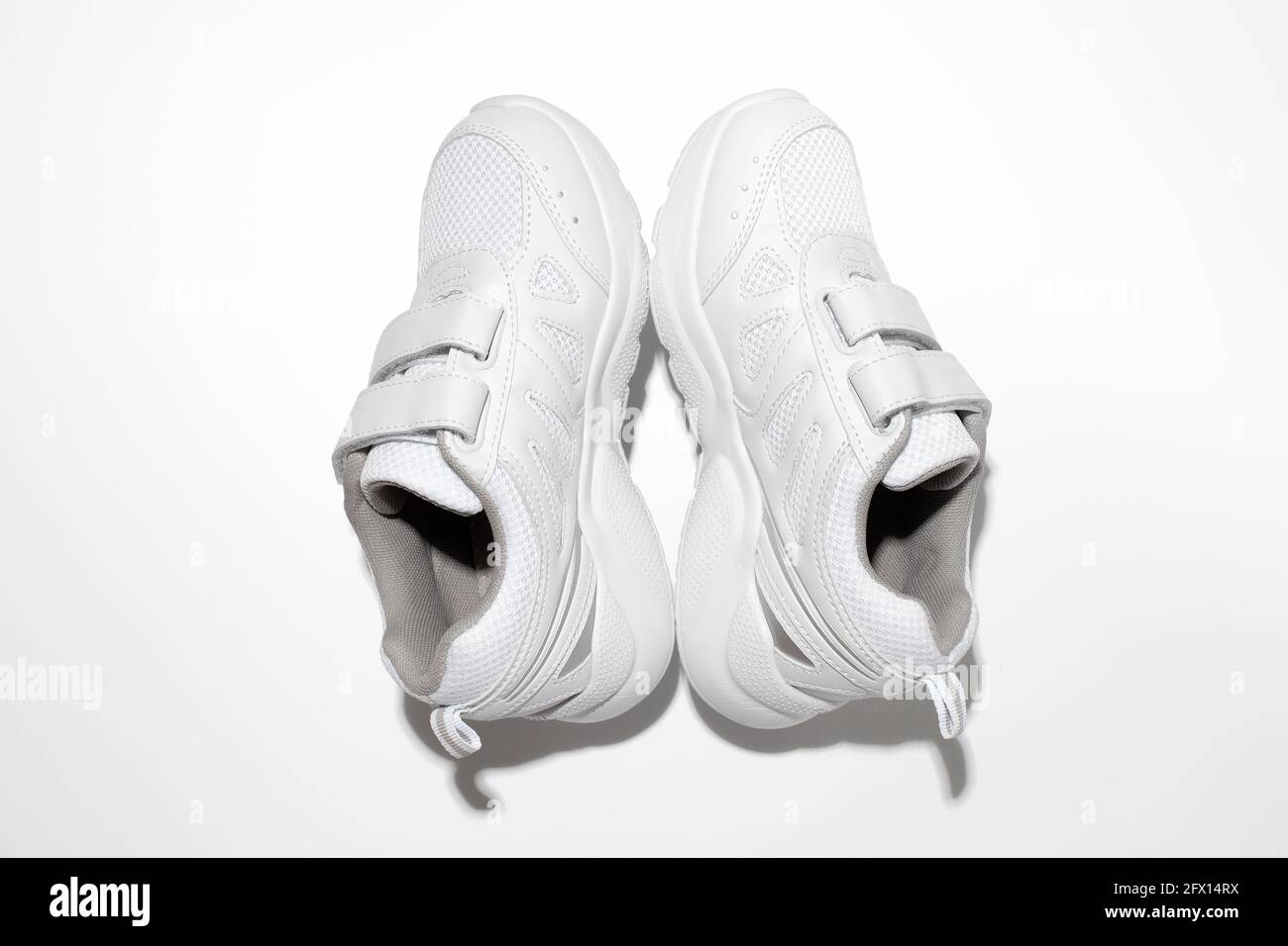 minimalistic flat lay white sneakers for women standing in the form of ...
