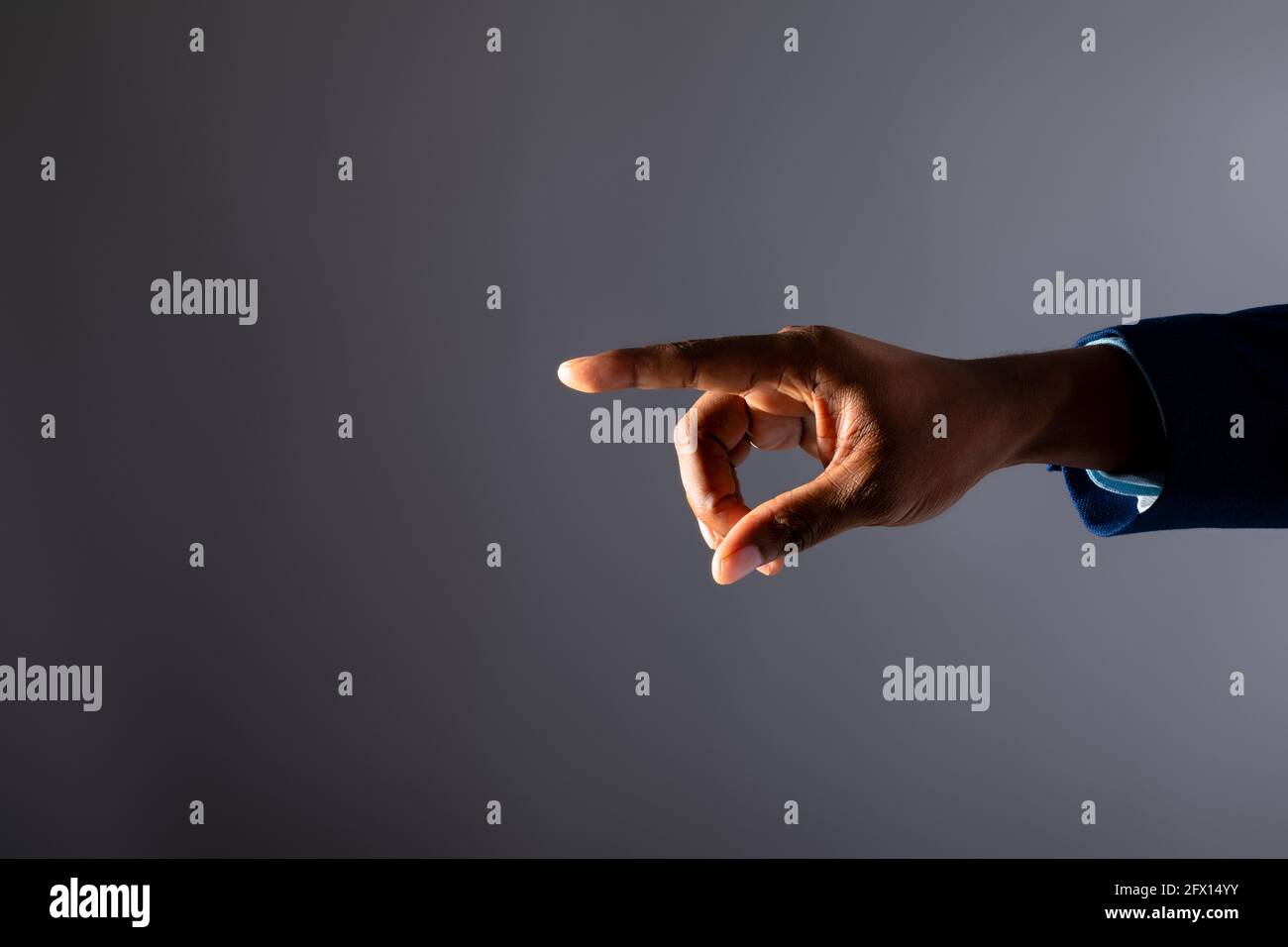 Mid section of african american businessman touching invisible screen ...