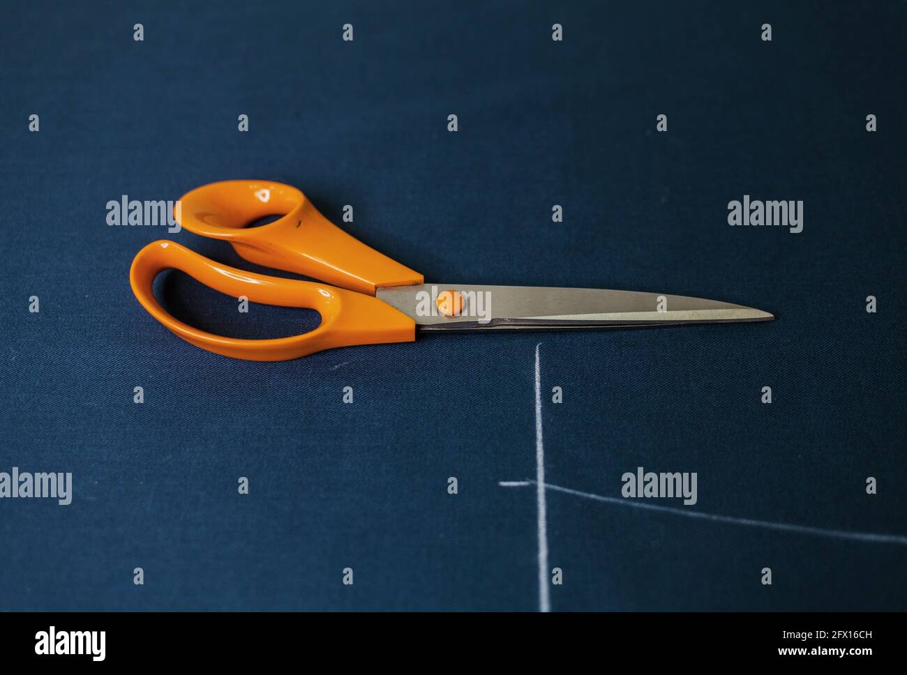 large tailor's scissors on the fabric. clothing manufacturing Stock ...