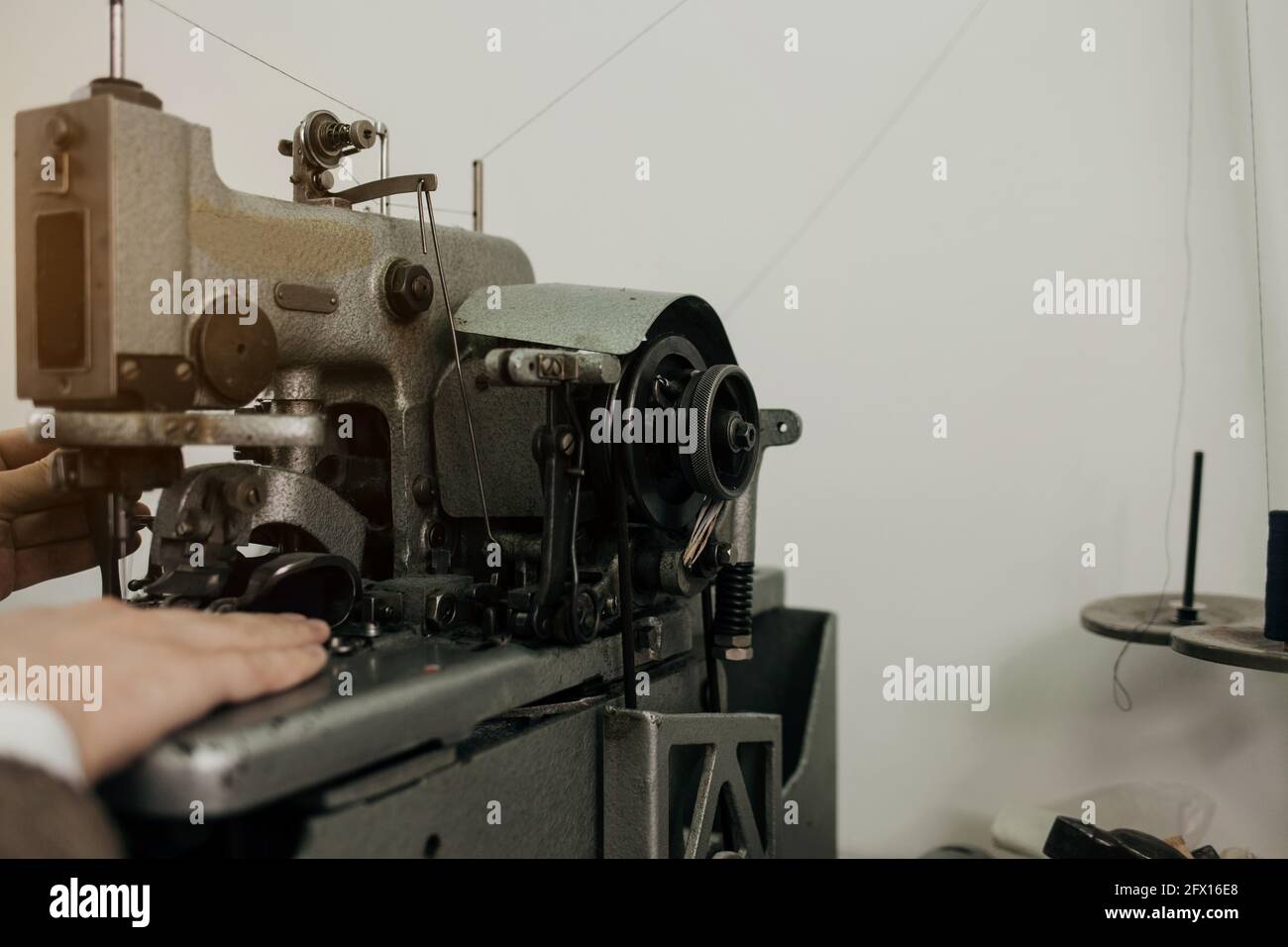 tailor on sewing machine and item of clothing, old sewing machine Stock ...