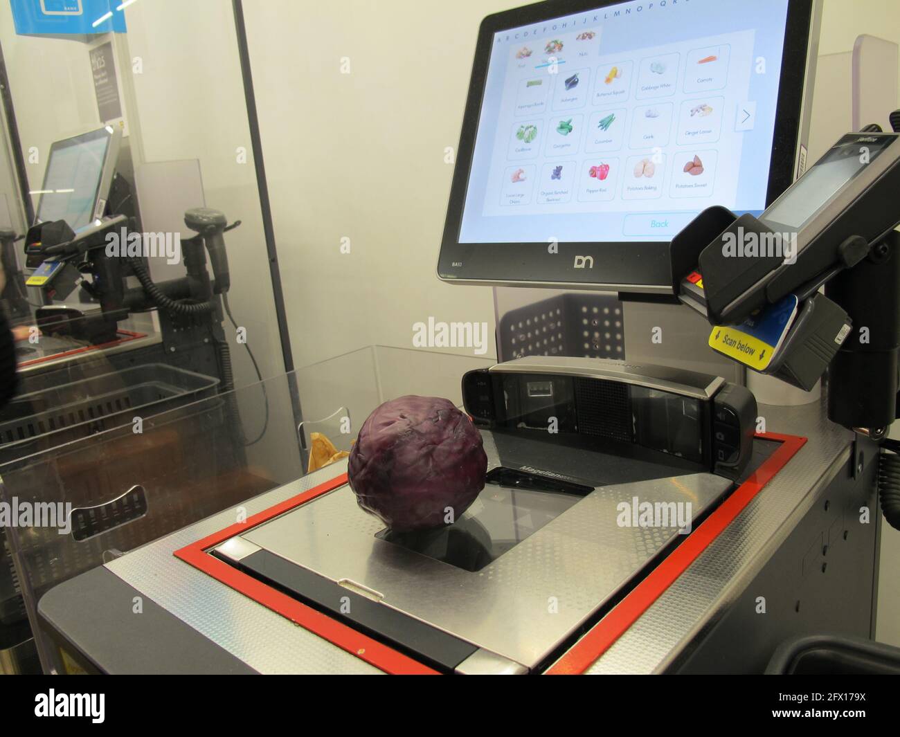 self service till scale with avocado being weighted Stock Photo - Alamy