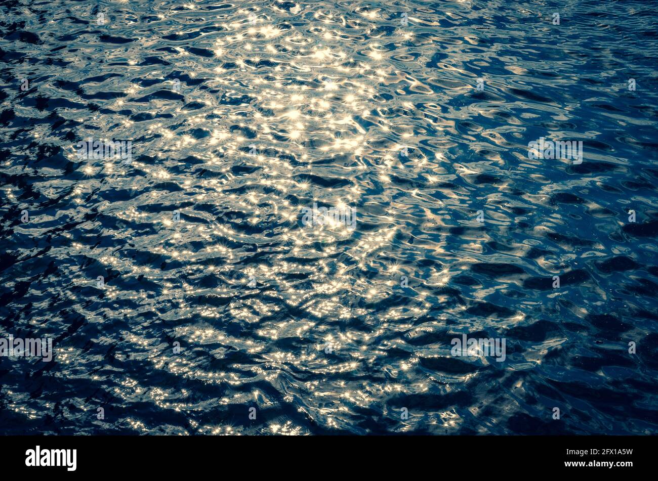 Dazzling and shimmering sun stars in the water - real photo Stock Photo ...