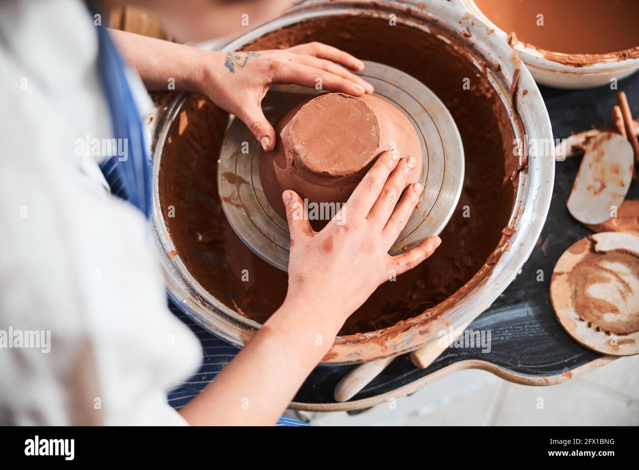 Pottery artist forming a bowl from clay with hands Stock Photo - Alamy