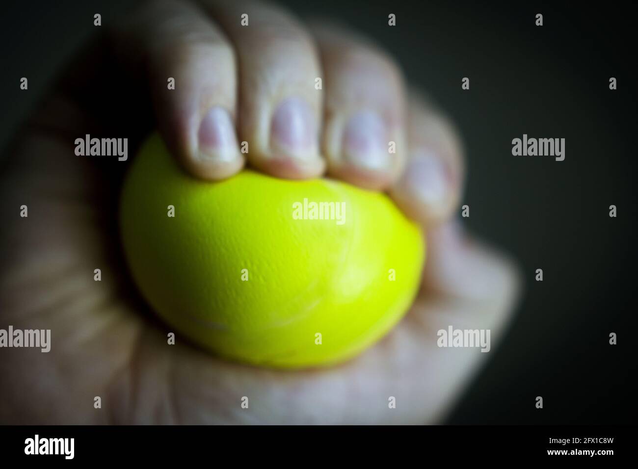 Exercises with one hand and yellow physiotherapy ball Stock Photo - Alamy