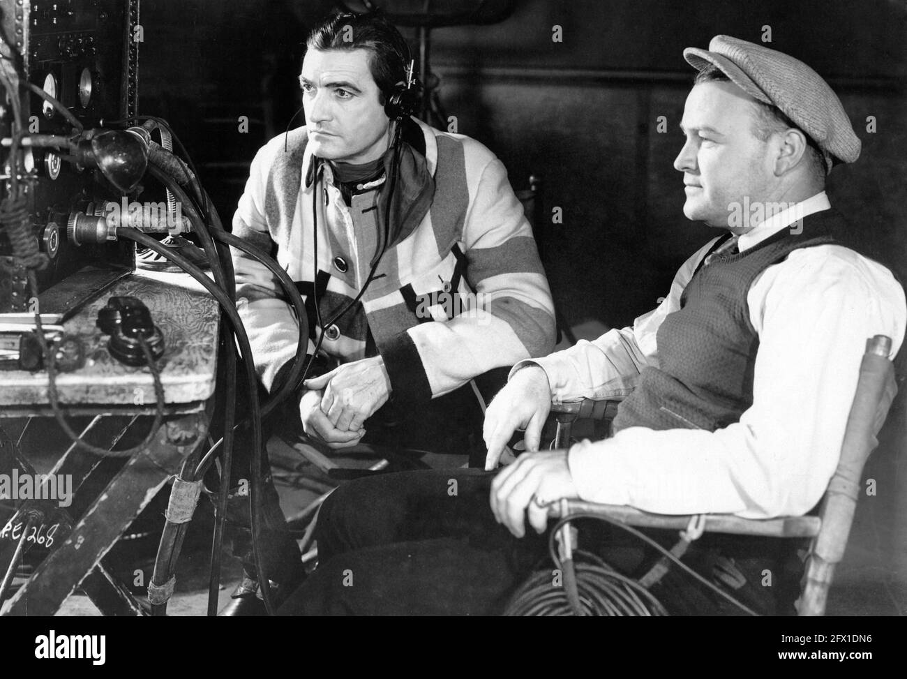 Cowboy Movie Star TOM MIX on set candid with Studio Technician checking ...