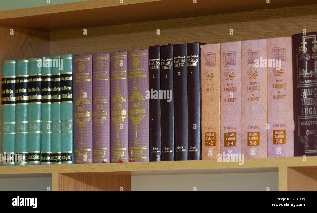 Volumes of Islamic religion books placed on a shelf of a school library ...