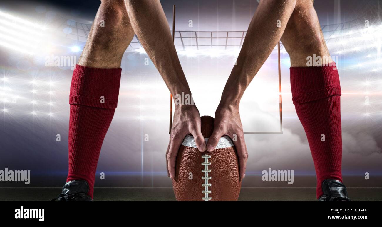 Composition of low section of rugby player with ball over sports ...