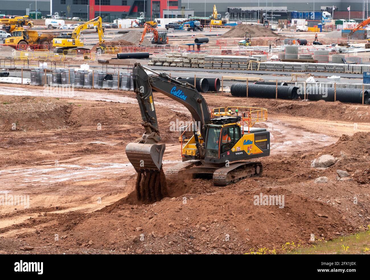Excavator moving soil on a construction site Stock Photo - Alamy