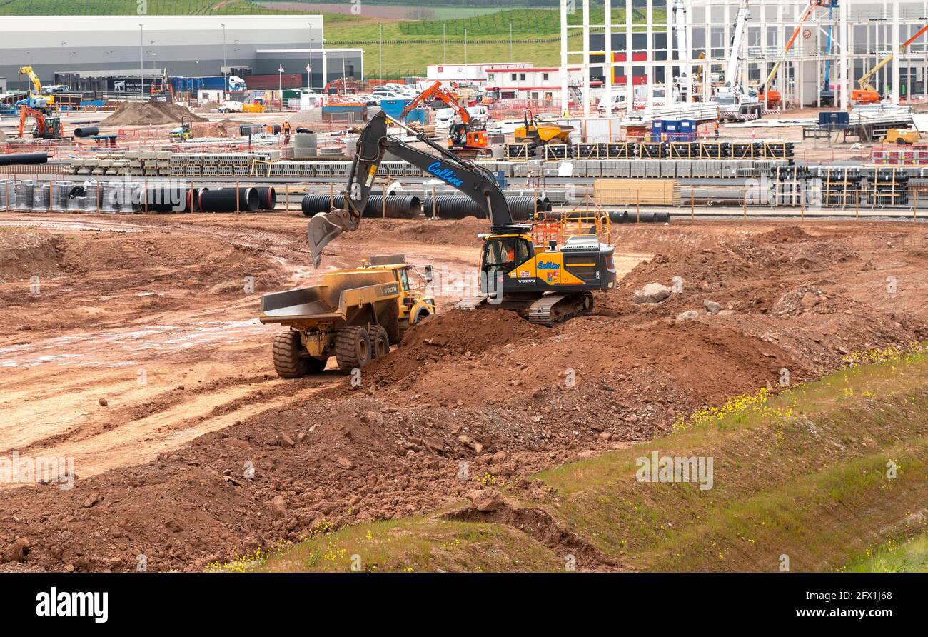 Excavator loading a dump truck with soil Stock Photo - Alamy