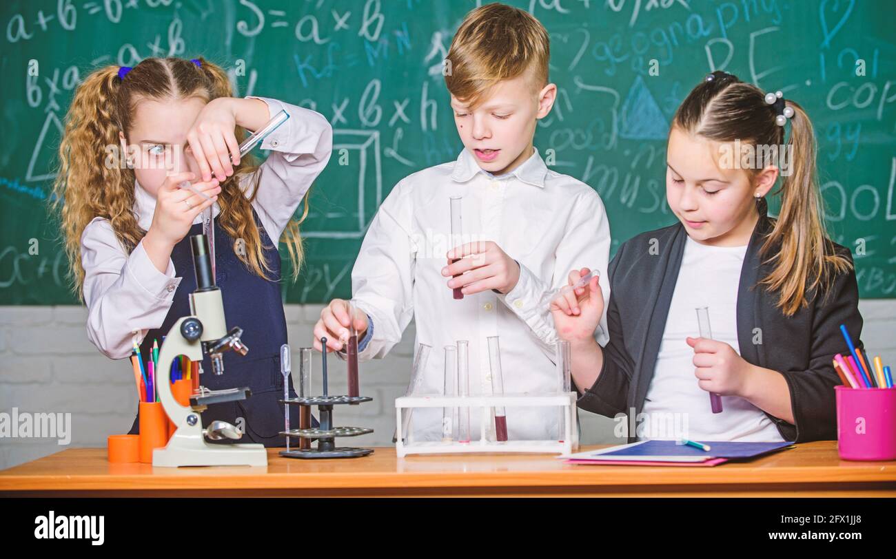 childrens day. students doing biology experiments with microscope ...
