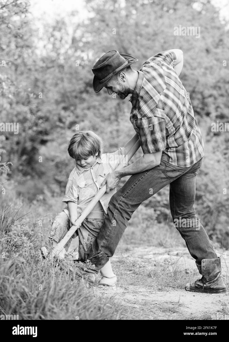 Little helper in garden. Cute child in nature having fun with cowboy ...