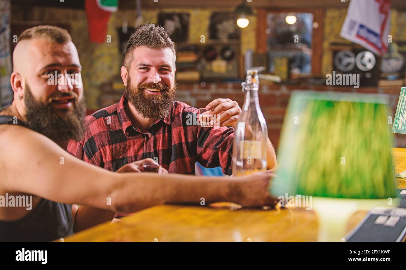 Strong alcohol drinks. Friends relaxing in pub. Alcohol addiction. Men ...