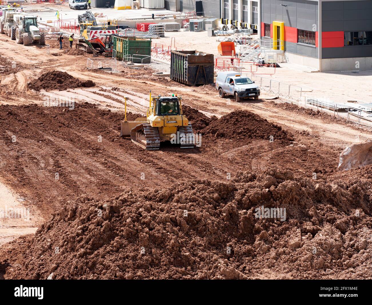Earth moving machines clearing land Stock Photo - Alamy