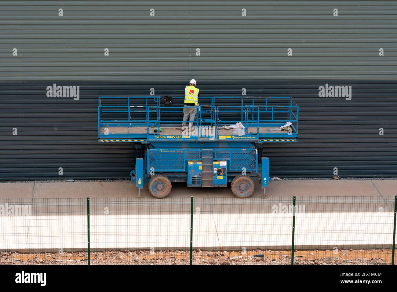 Worker alone on a mobile work platform Stock Photo - Alamy