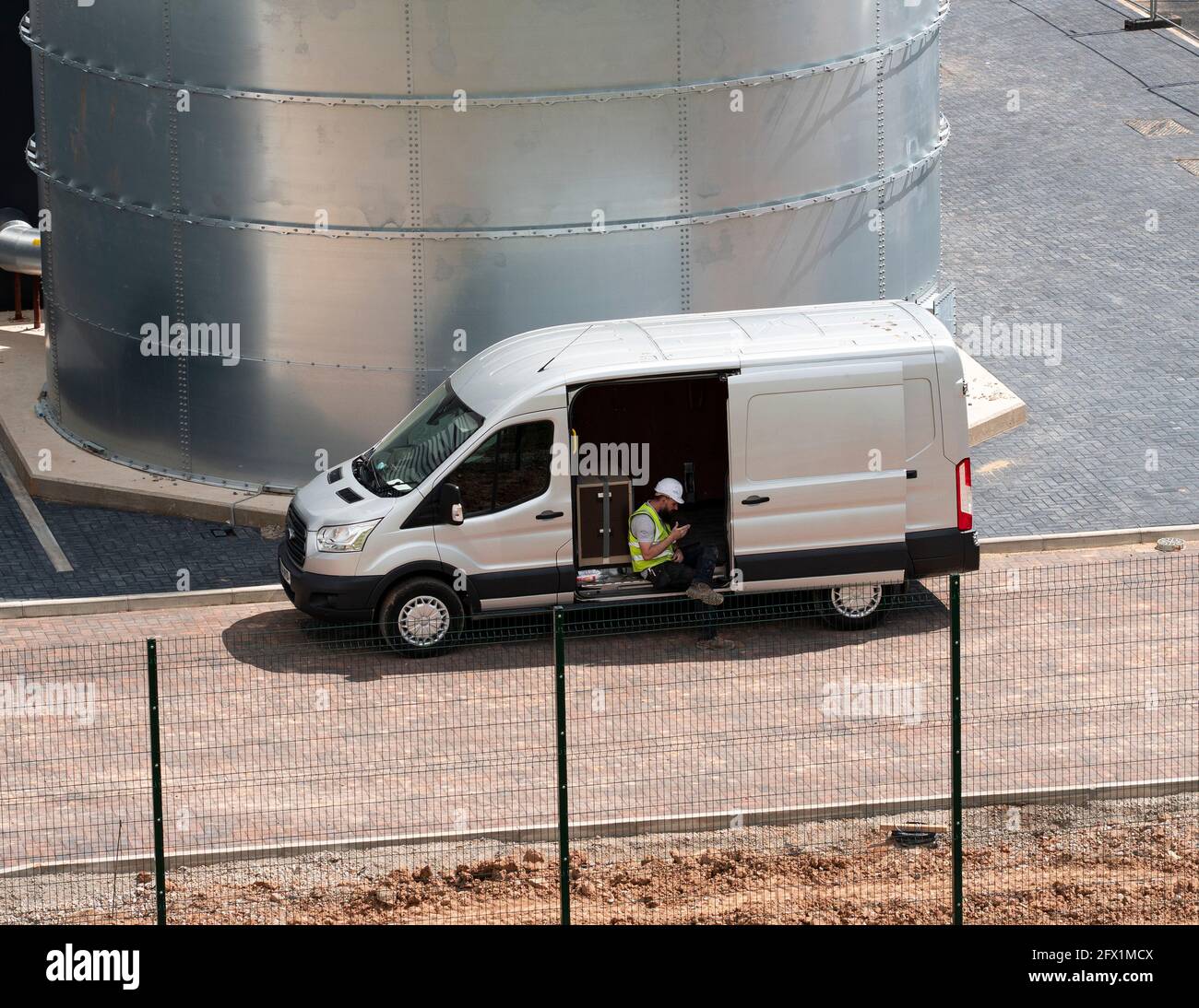 Worker taking a break in a van Stock Photo - Alamy