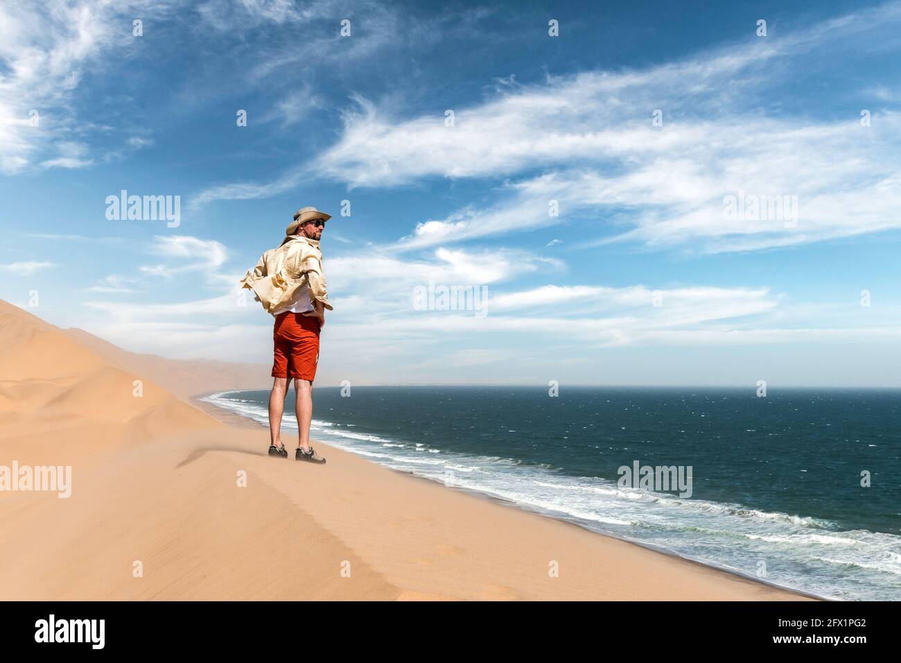 Single man in a cowboy hat in the Namib desert on Atlantic ocean ...