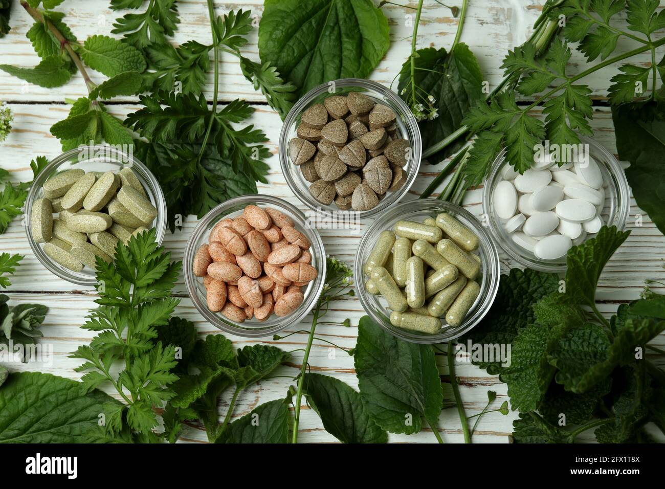 Concept of herbal medicine pills on white wooden table, top view Stock ...