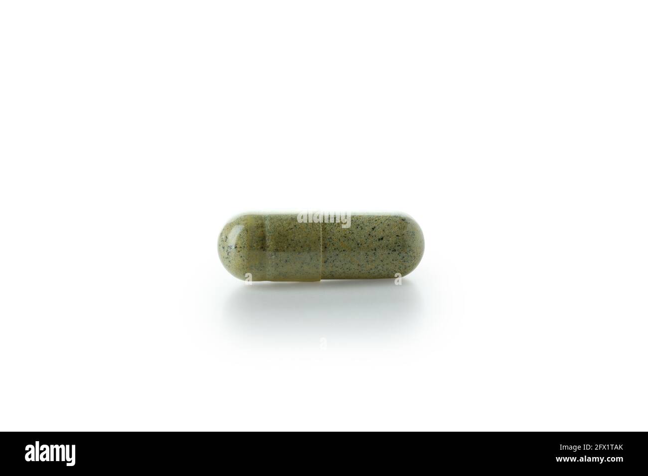 Herbal powder capsule isolated on white background Stock Photo - Alamy