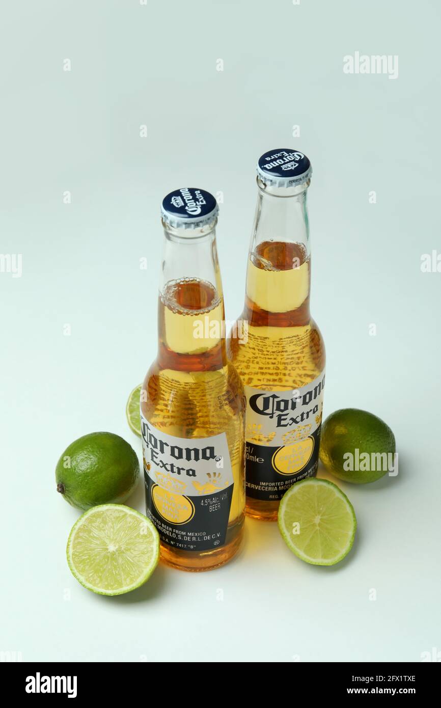Bottles of Corona Extra and limes on white background Stock Photo - Alamy