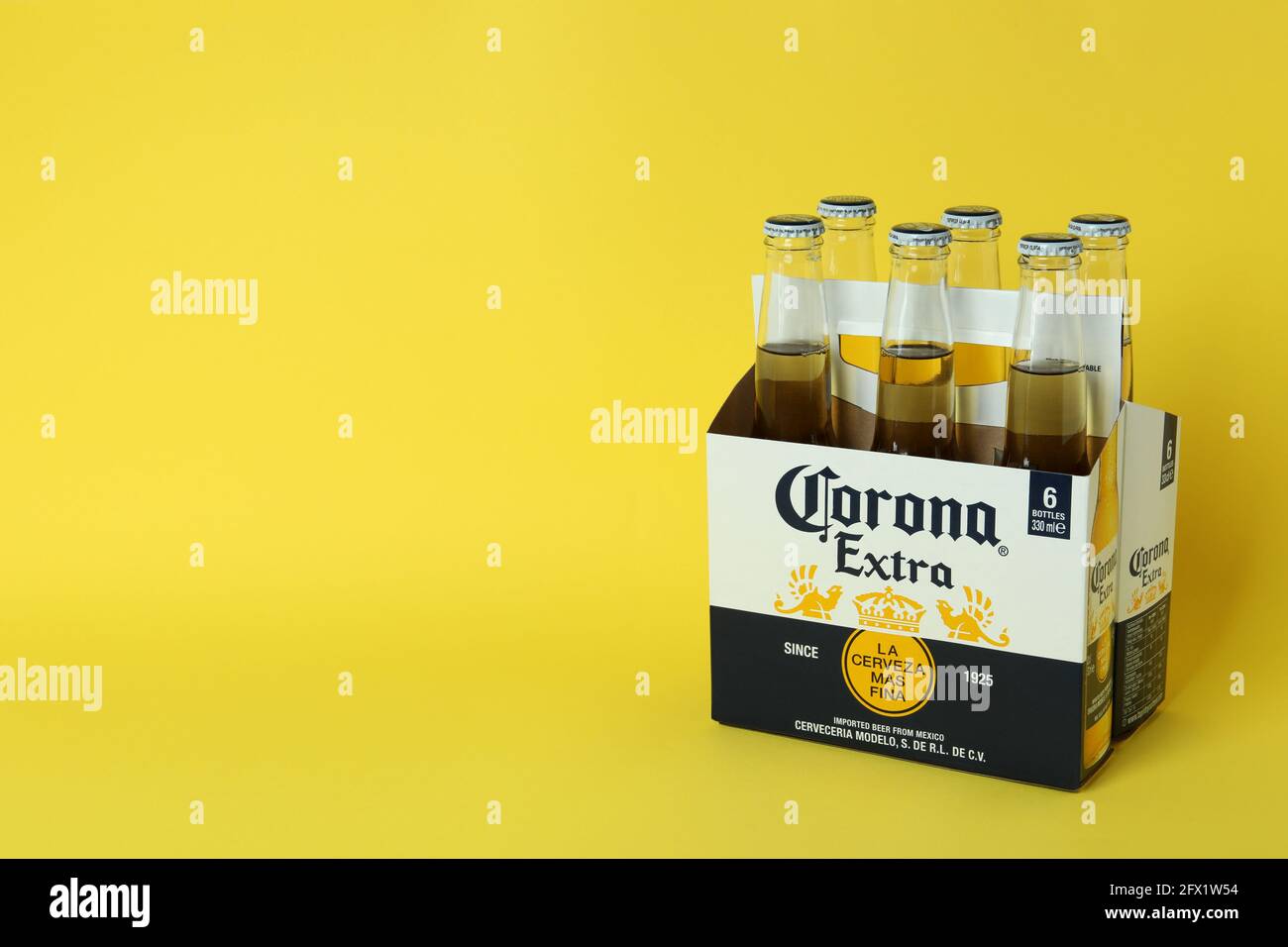 Carton box with Corona Extra on yellow background Stock Photo - Alamy