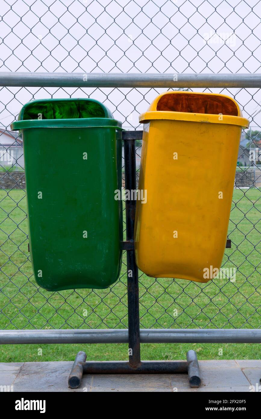 Green and yellow trash bin at outdoor Stock Photo - Alamy