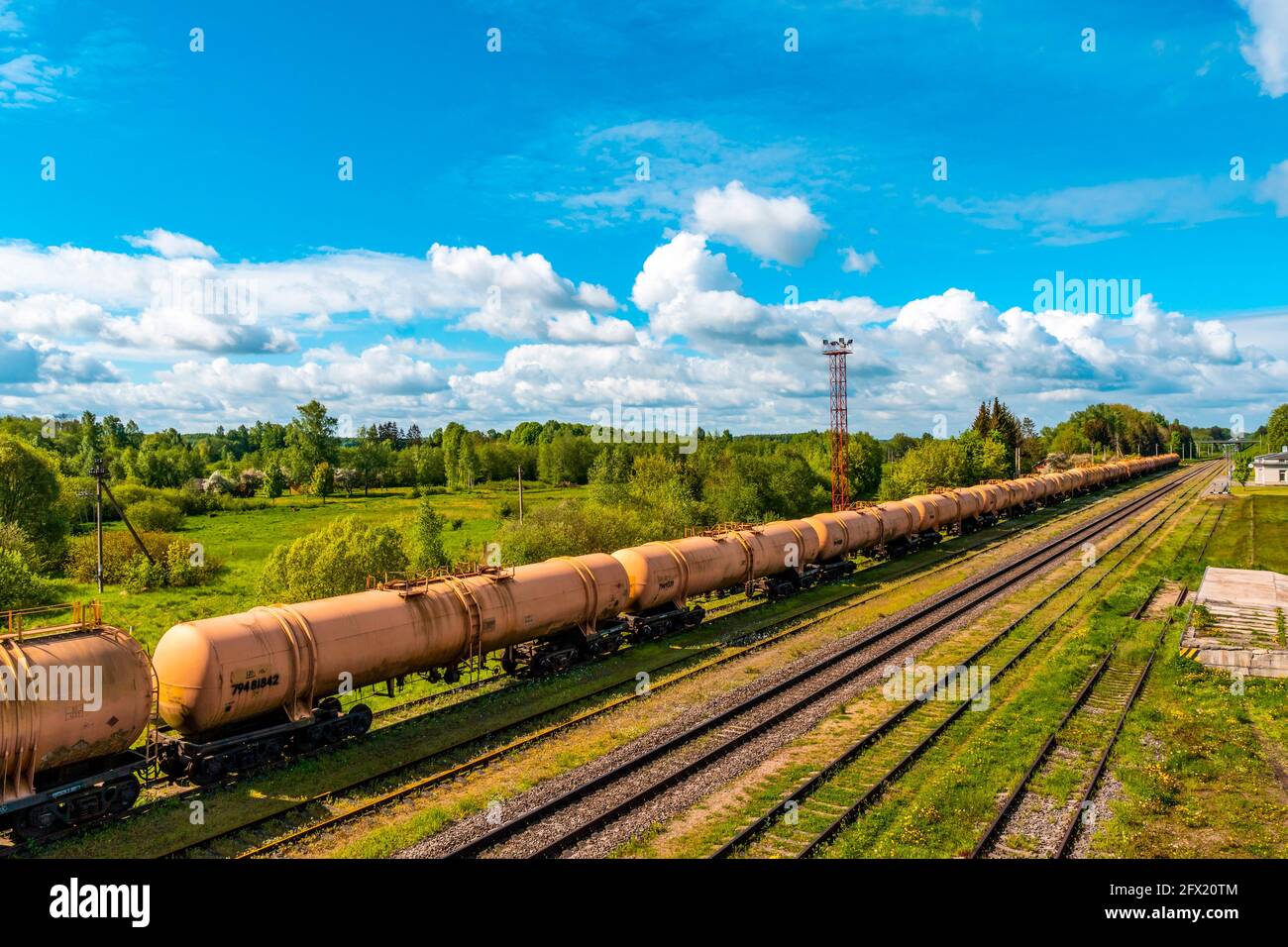 The freight train passes by the station. Set of train tanks with fuel ...