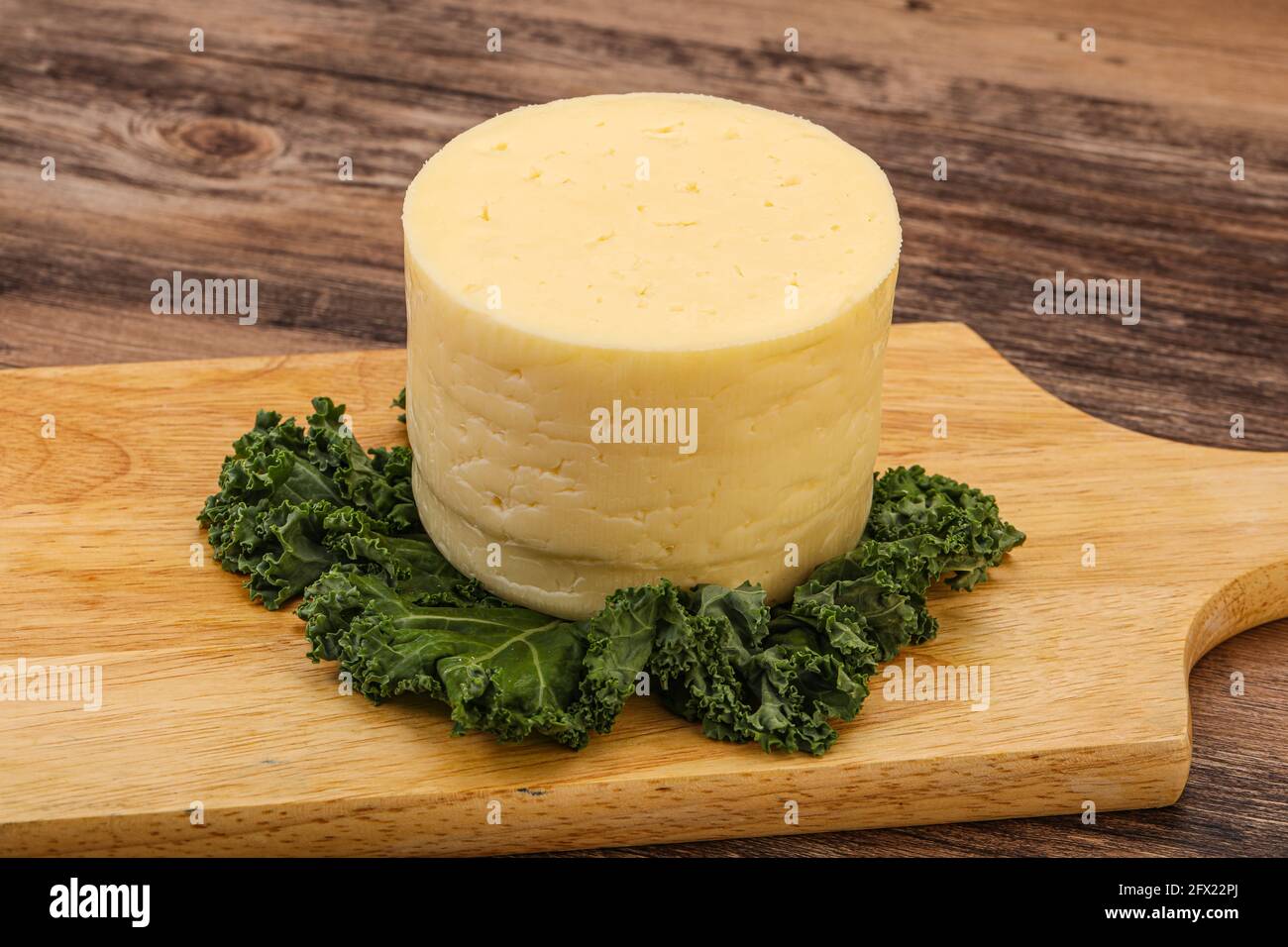 Yellow round dairy soft cheese piece Stock Photo - Alamy