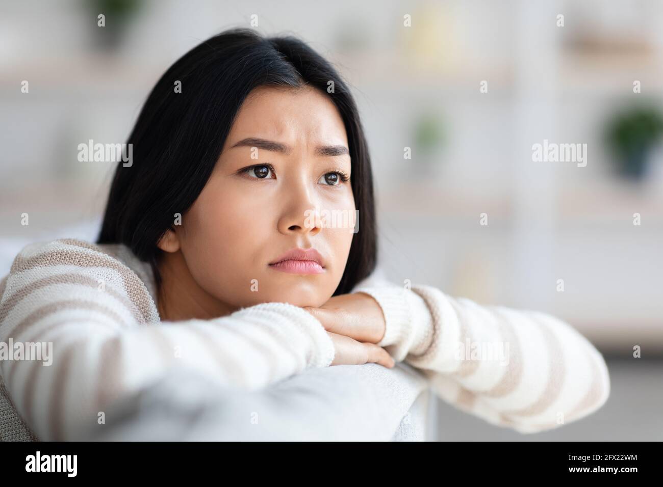 Depression Concept. Closeup Of Upset Asian Female Sitting On Couch At ...
