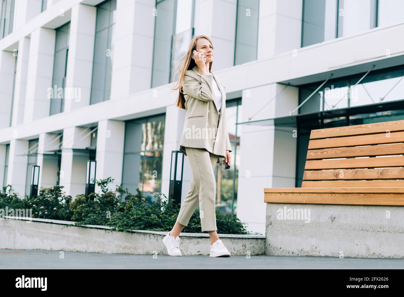 Woman blonde walking talking hi-res stock photography and images - Alamy