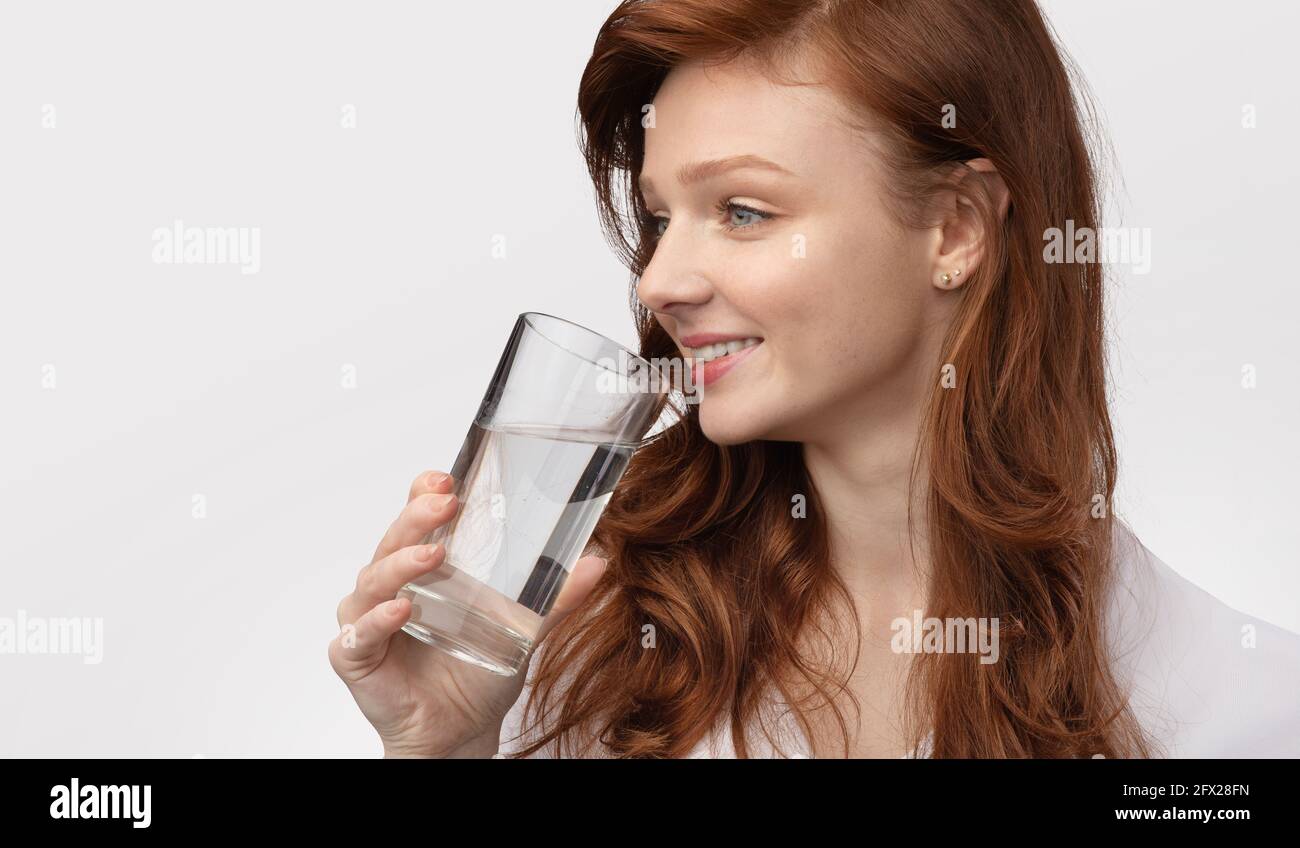 Side View Of Red-Haired Girl Drinking Water Over White Background Stock ...