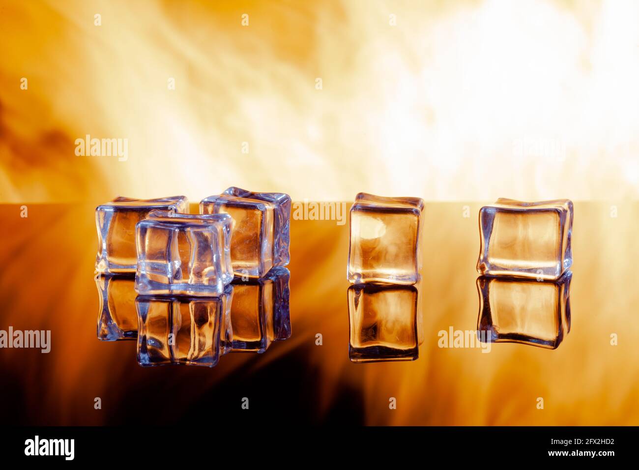 five ice cubes against the flames, copy space Stock Photo - Alamy