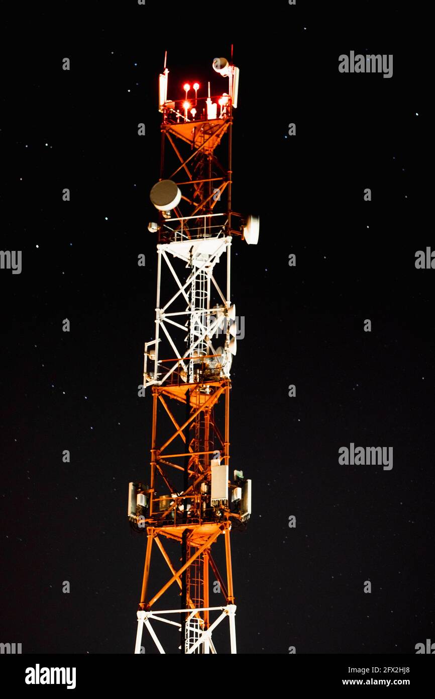 Telecommunications tower with antennas on the background of the starry ...