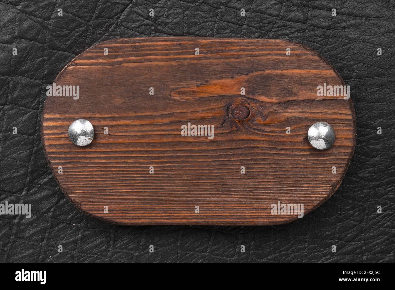 Sign made from a board, fastened with iron rivets on black leather. Top ...