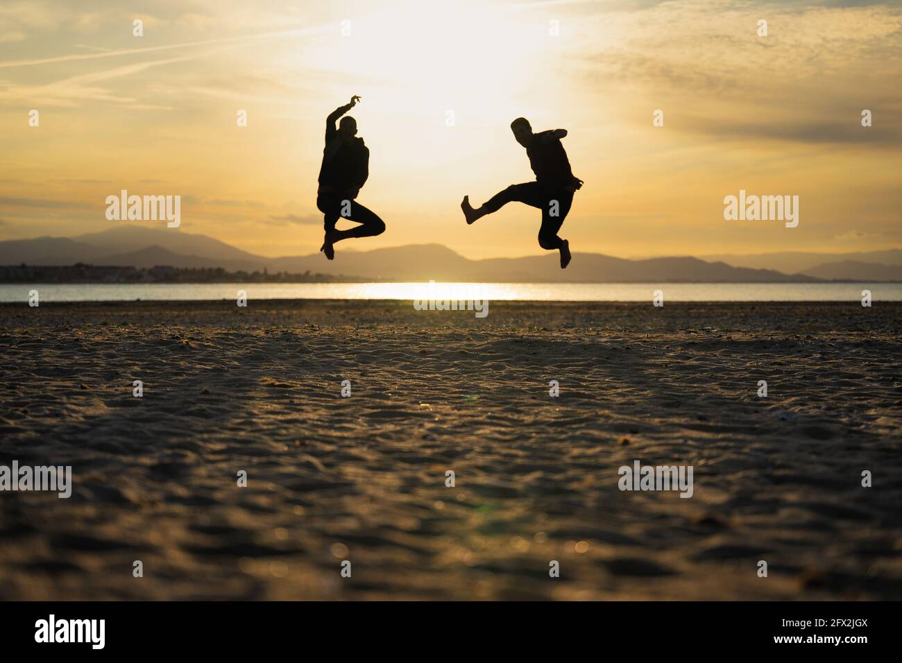 Couple on beach sunrise time hi-res stock photography and images - Alamy