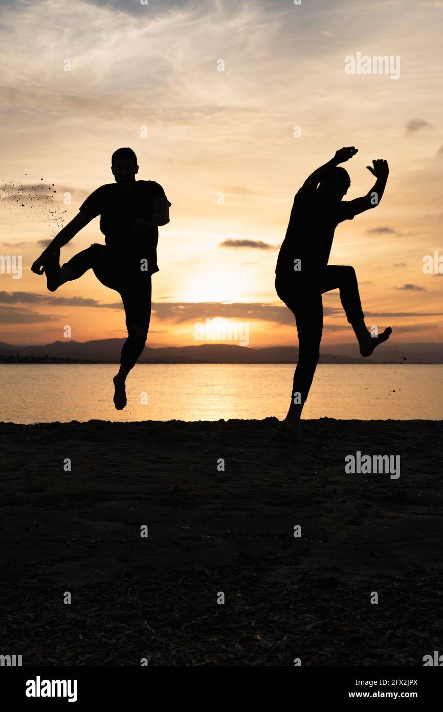 Happy people couple love jump jumping beach sunset hi-res stock ...