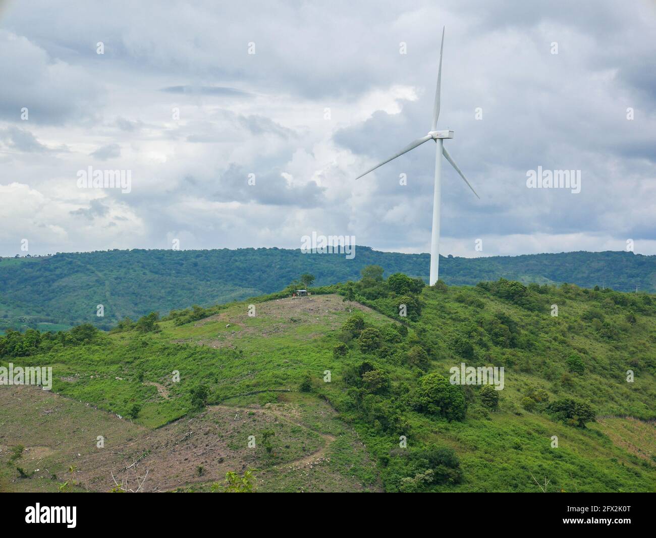Wind turbines on the green hilly terrain with the bright blue sky Stock ...