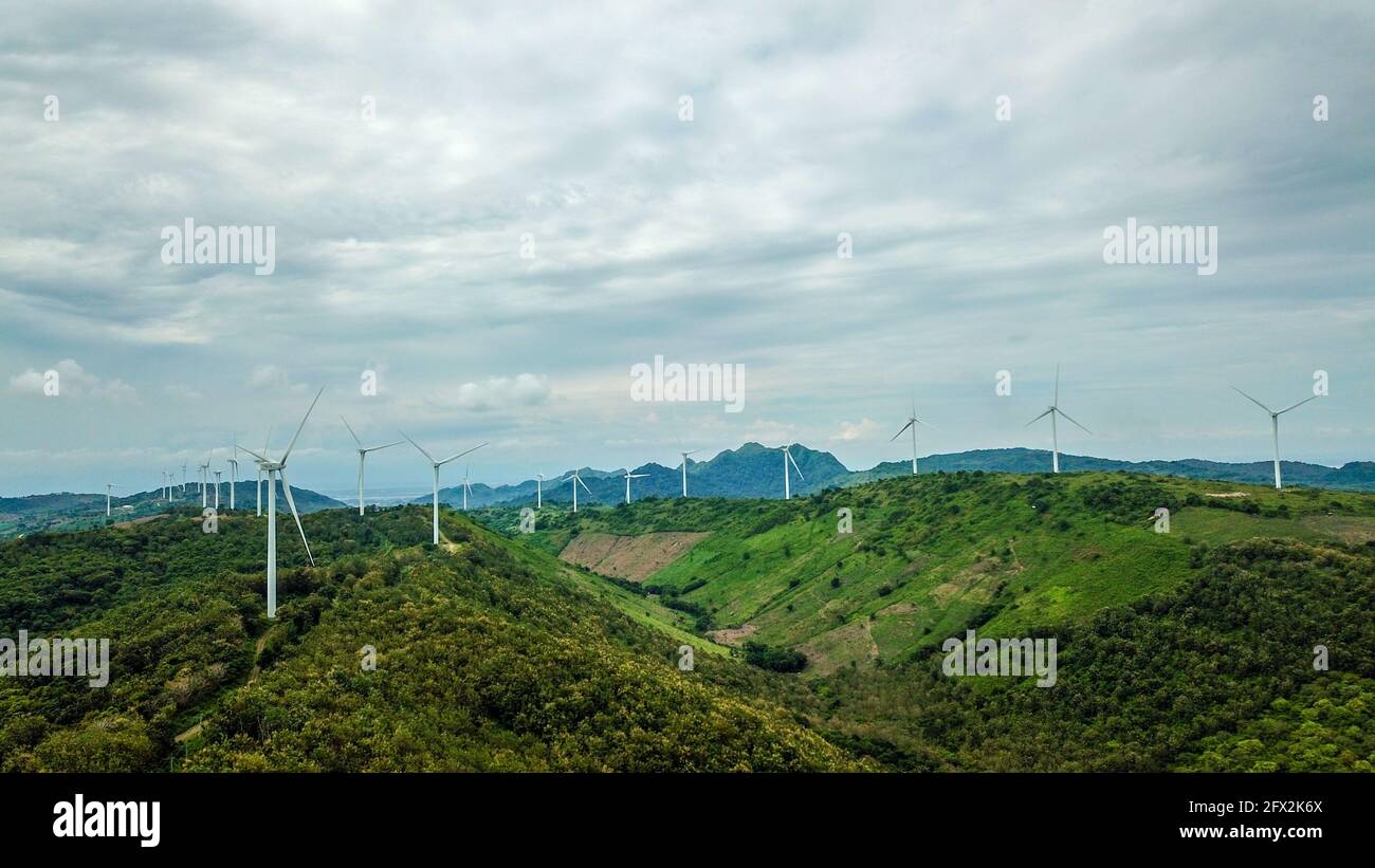 Wind turbines on the green hilly terrain with the bright blue sky Stock ...