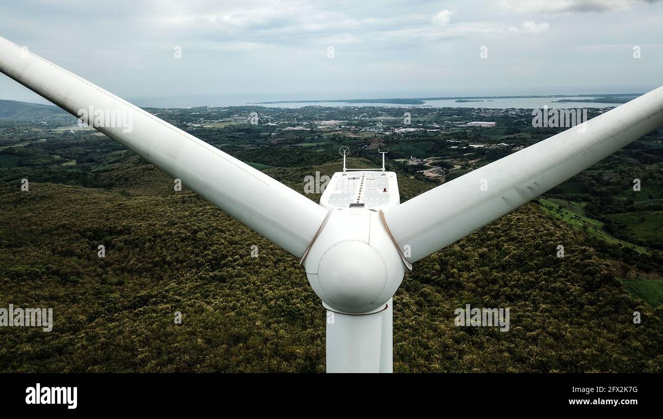 Wind turbines on the green hilly terrain with the bright blue sky Stock ...