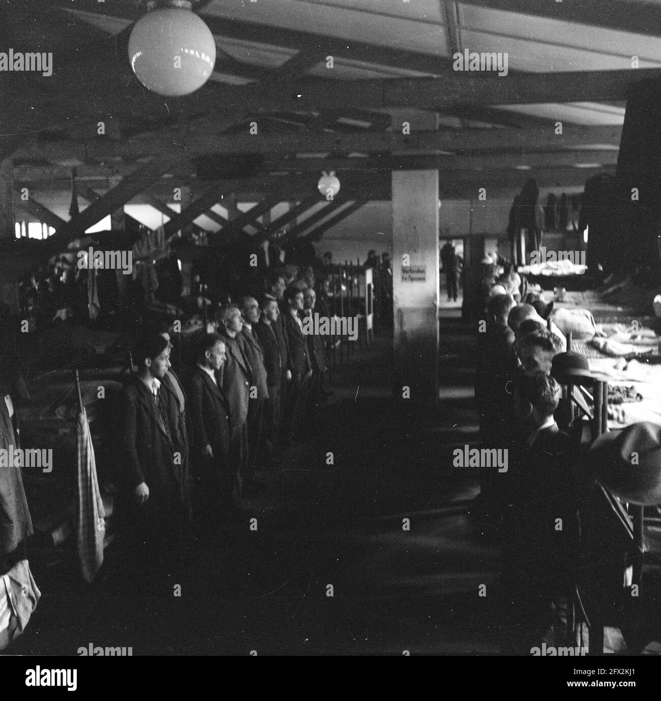 [Men stand embarked inside a barracks], 1945, internment camps, The ...