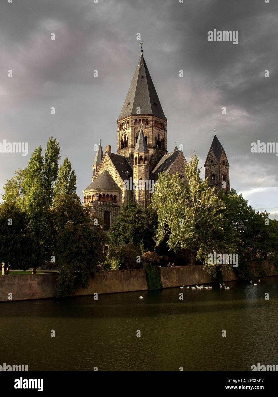 The building, of style Romanesque, is topped by five towers and ...