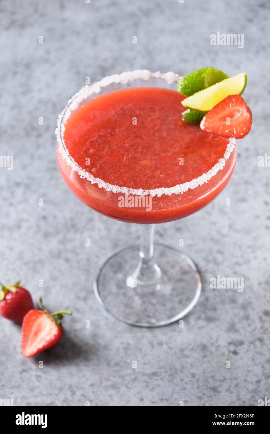 Strawberry Margarita cocktail or smoothie garnish lime on gray ...