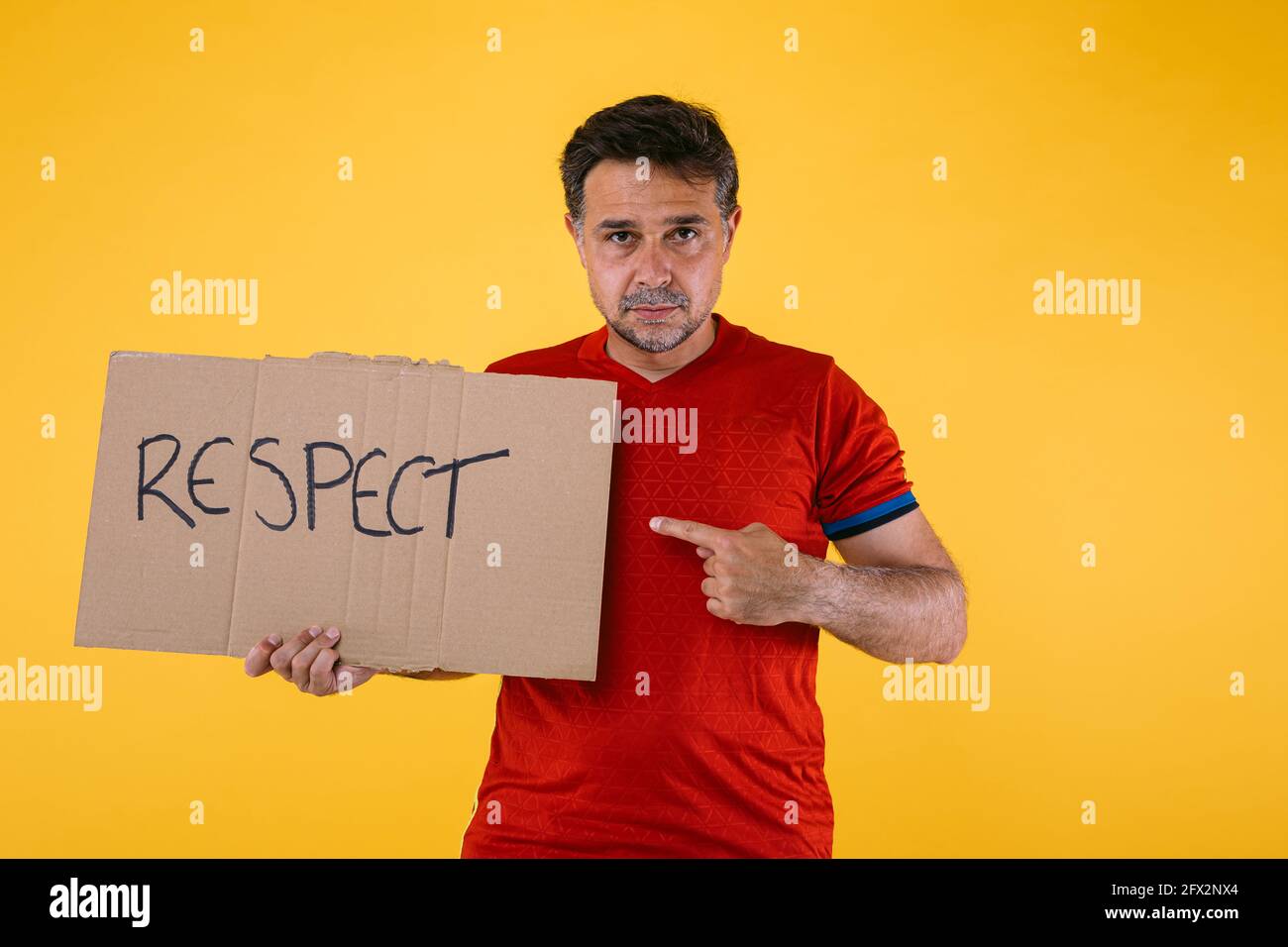 Soccer fan with red shirt and a sign that says 'Respect' Stock Photo ...