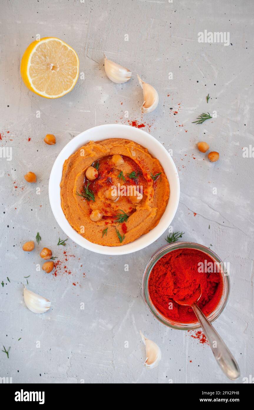 Flat lay of a bowl of delicious hummus with olive oil, garlic and ...
