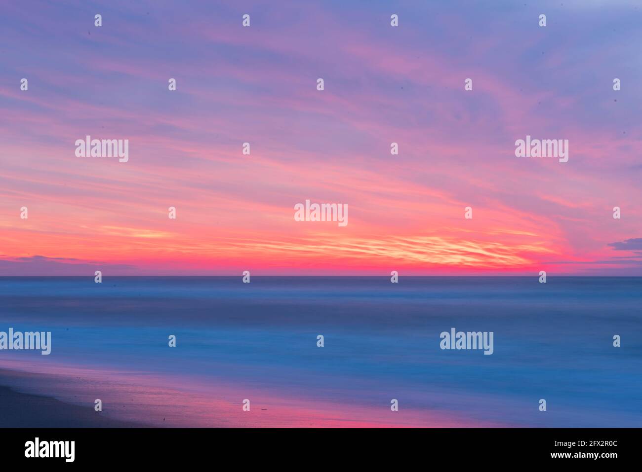 The moments before the sun rises are awash in beautiful pink hues ...