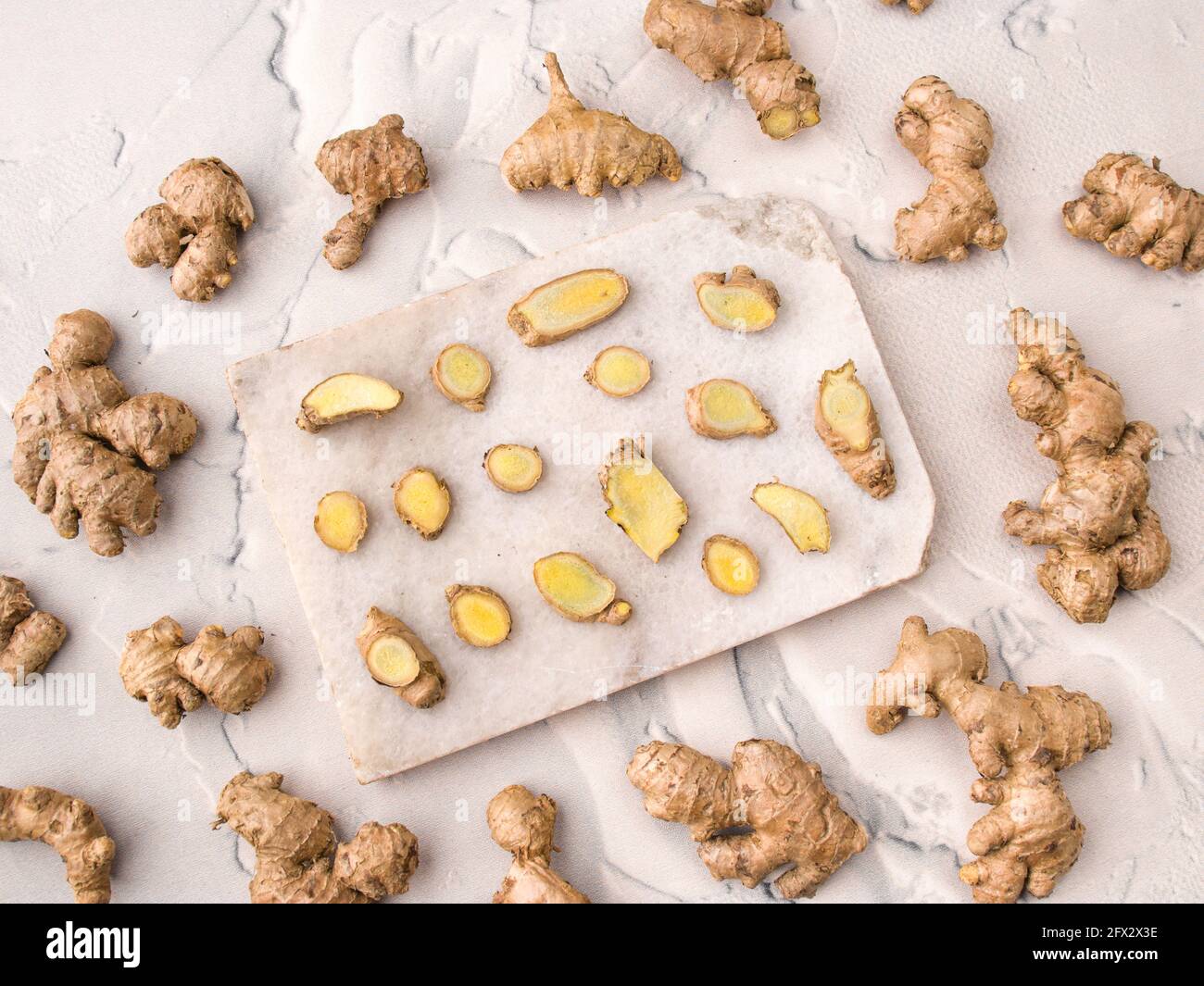 Fresh Ginger on white texture background stock image Stock Photo - Alamy
