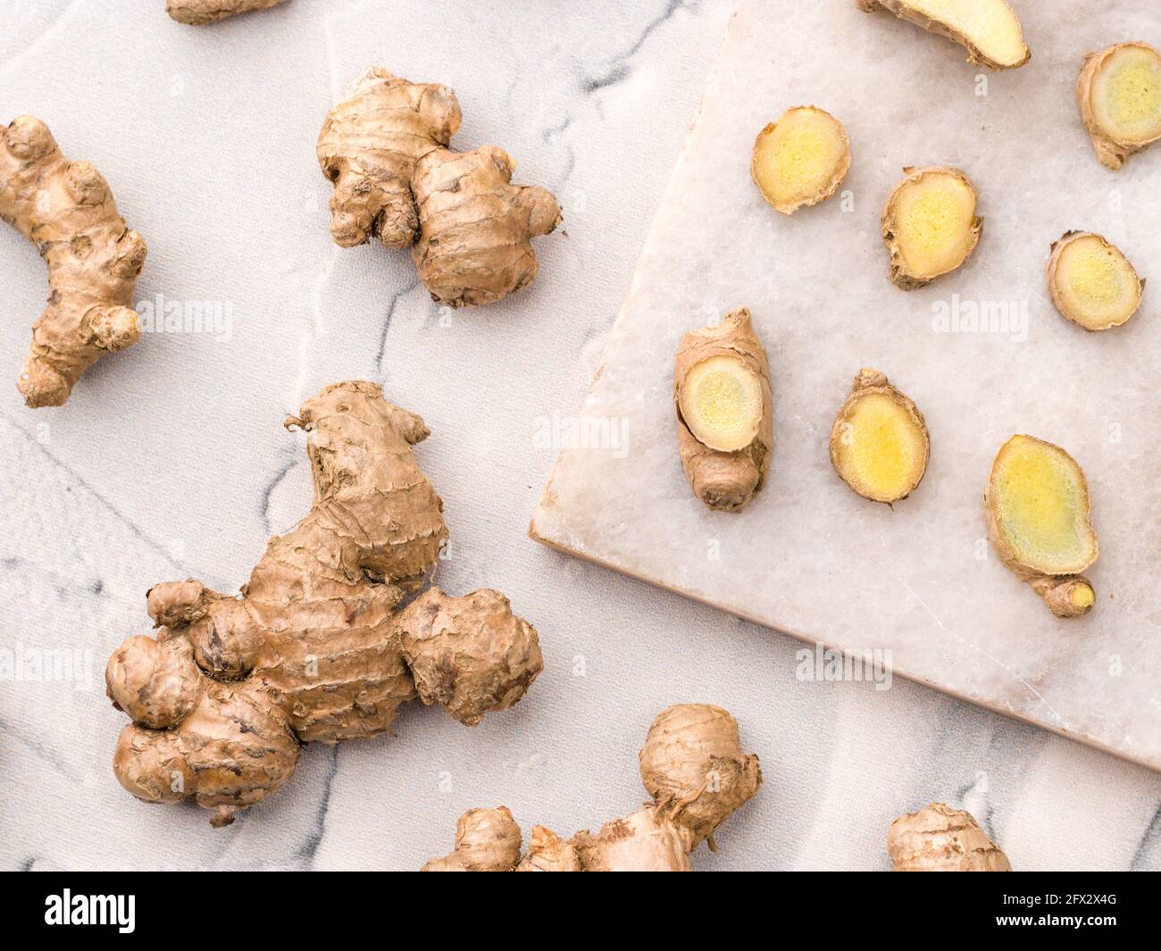 Fresh Ginger on white texture background stock image Stock Photo - Alamy